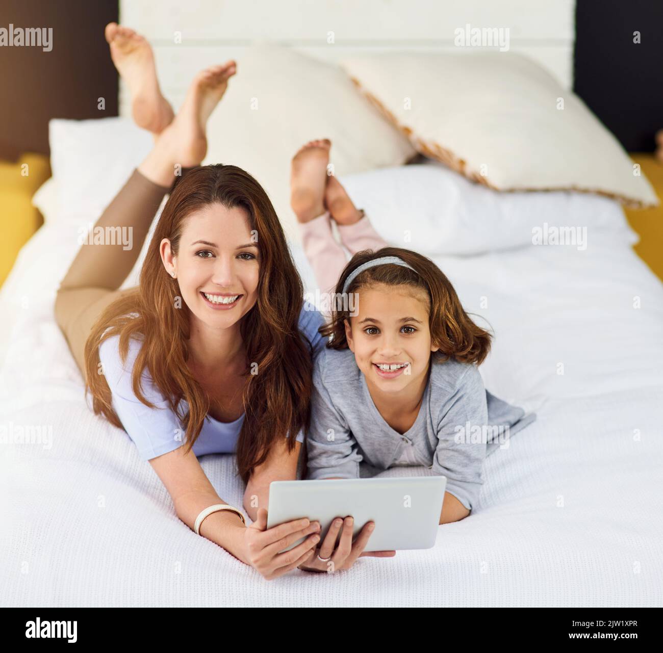 Mommy And Me Full Length Portrait Of A Mother And Her Daughter Using A Digital Tablet Stock
