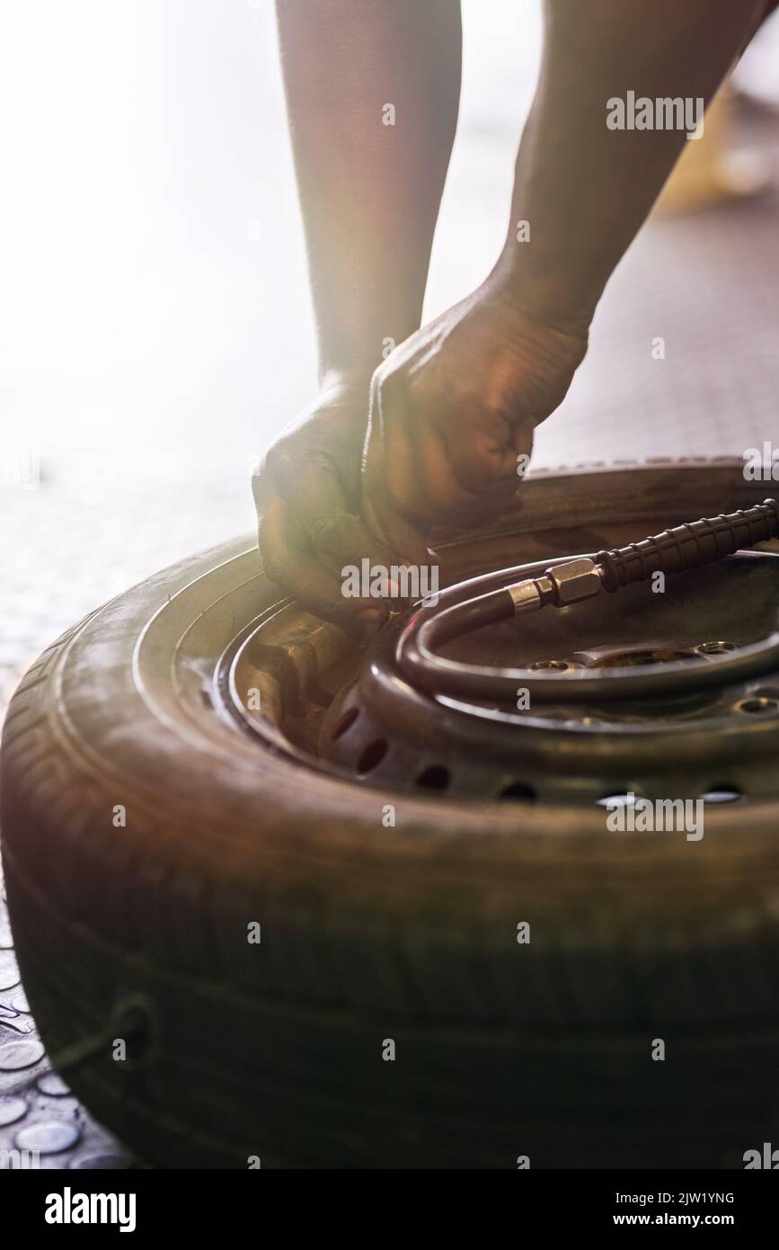 Tyres and tools. a mechanic repairing a car tyre Stock Photo - Alamy