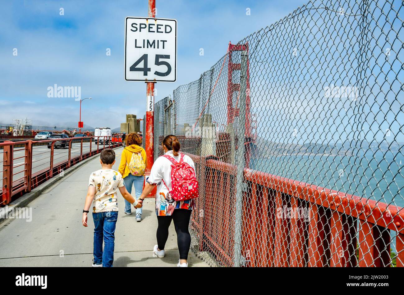 A Mother and son walk hand in hand together across The Golden Gate ...