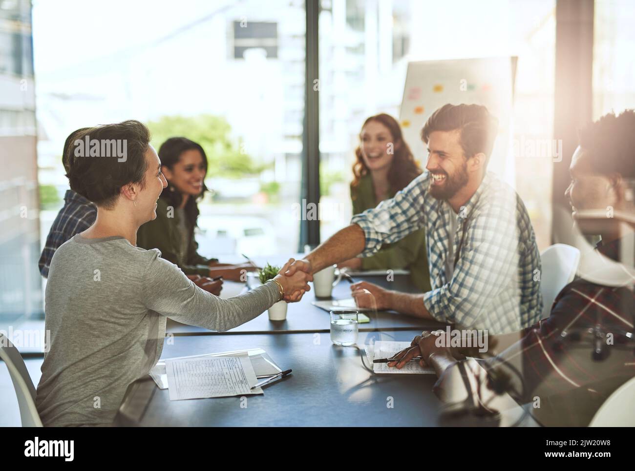 Keep up the great work. businesspeople shaking hands in a modern office ...