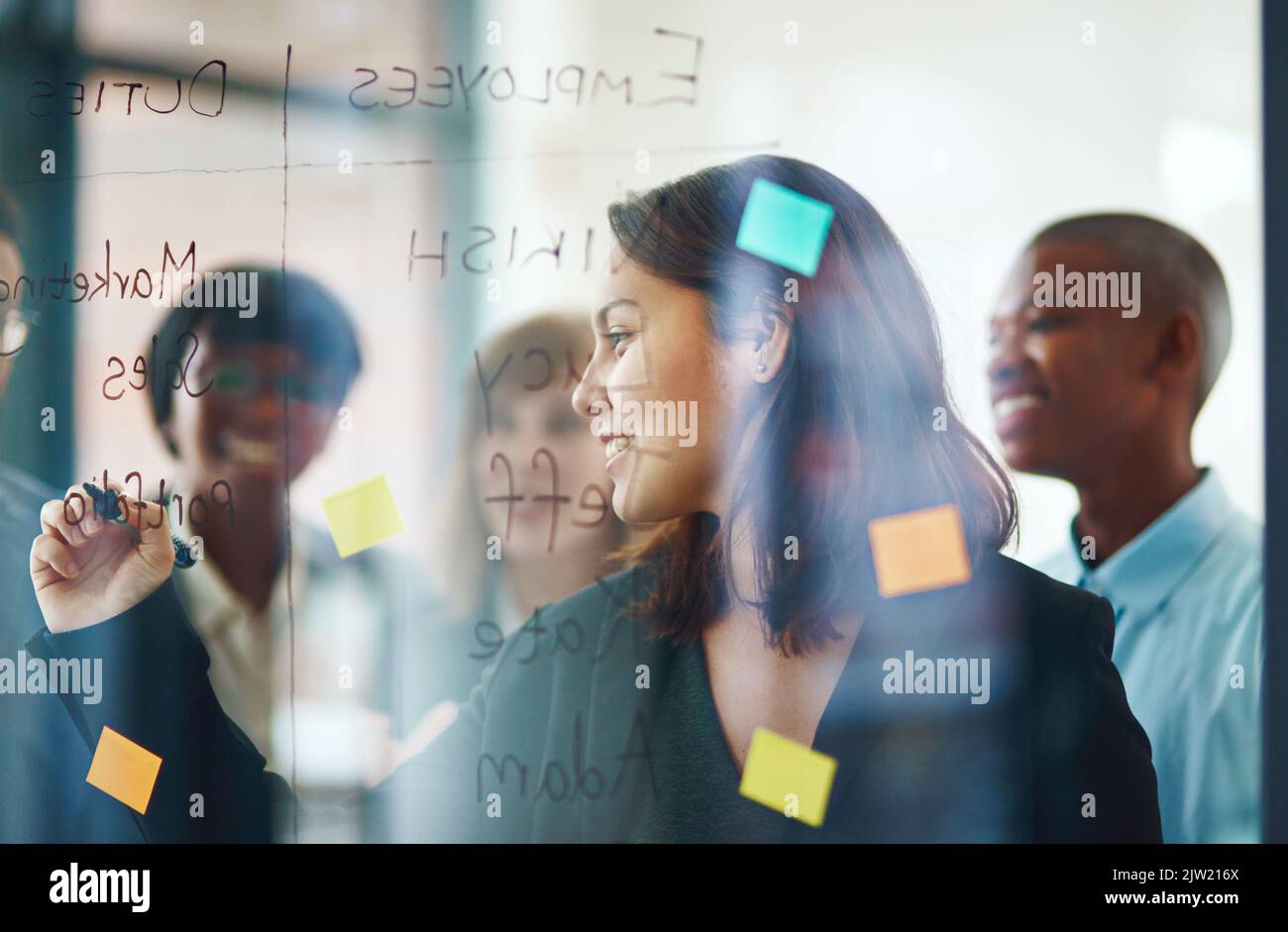 Making success their priority. a group of businesspeople brainstorming ...