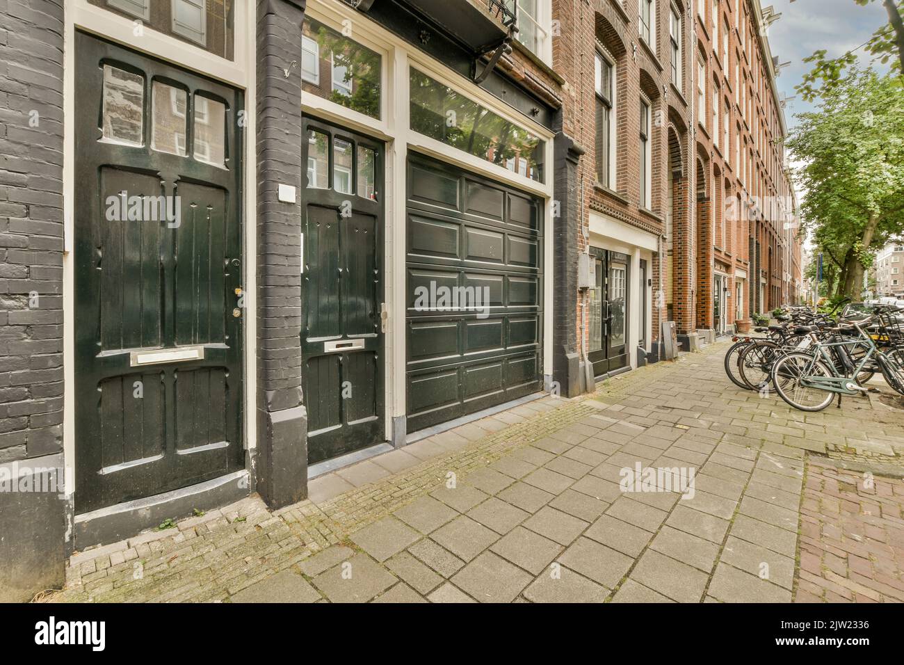 Front view of old brick buildings and cars with bicycles from small ...