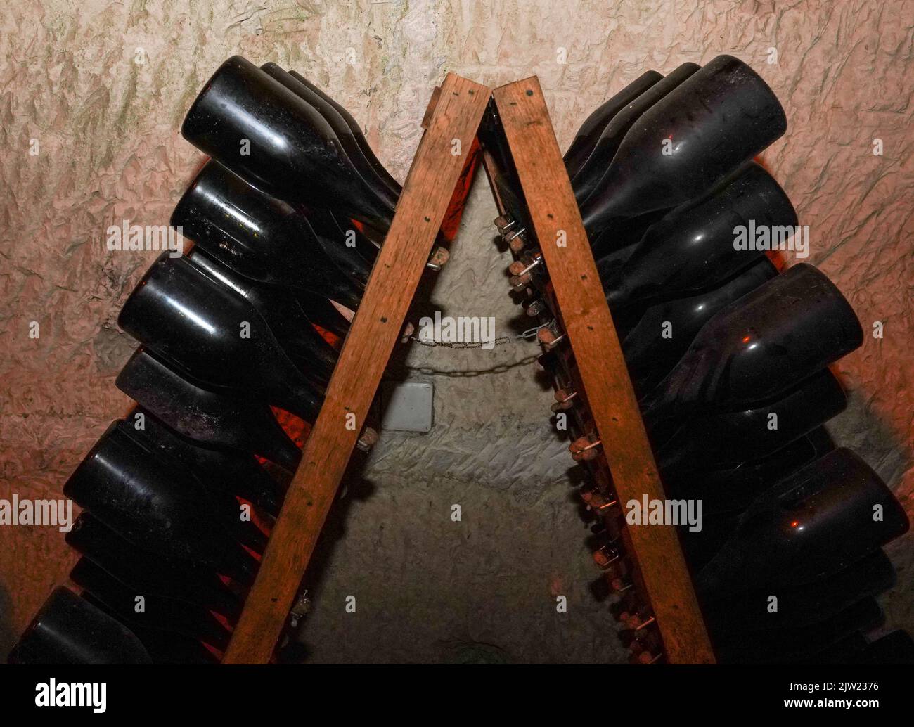 Champagne bottles in pupitre in Reims, France. Remuage, or riddling, of ...