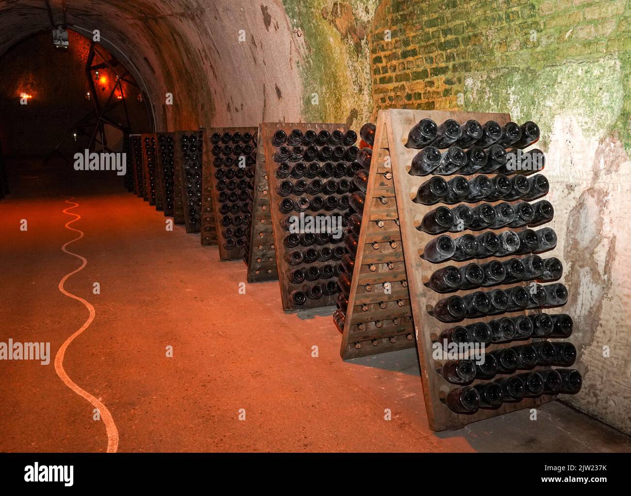 Champagne bottles in pupitre in Reims, France. Remuage, or riddling, of ...