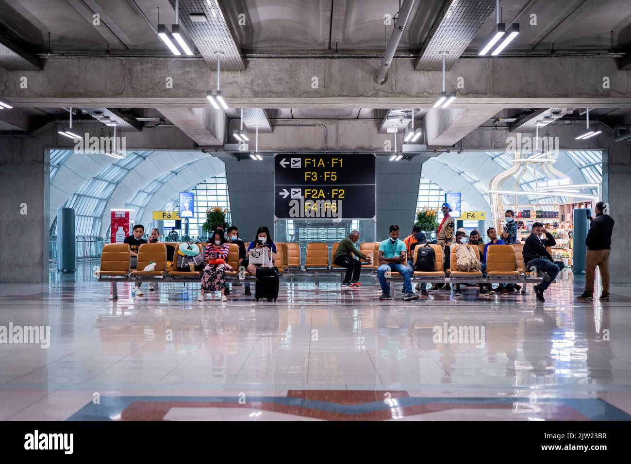 Travelers wait for flights inside the international departures terminal ...