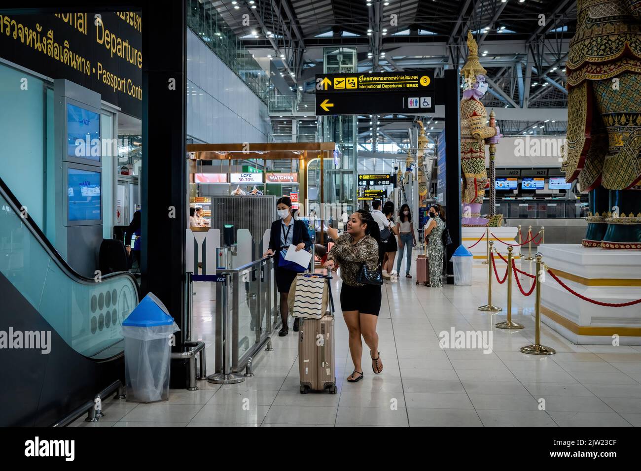 A traveler takes a photo of another departing passenger inside the ...