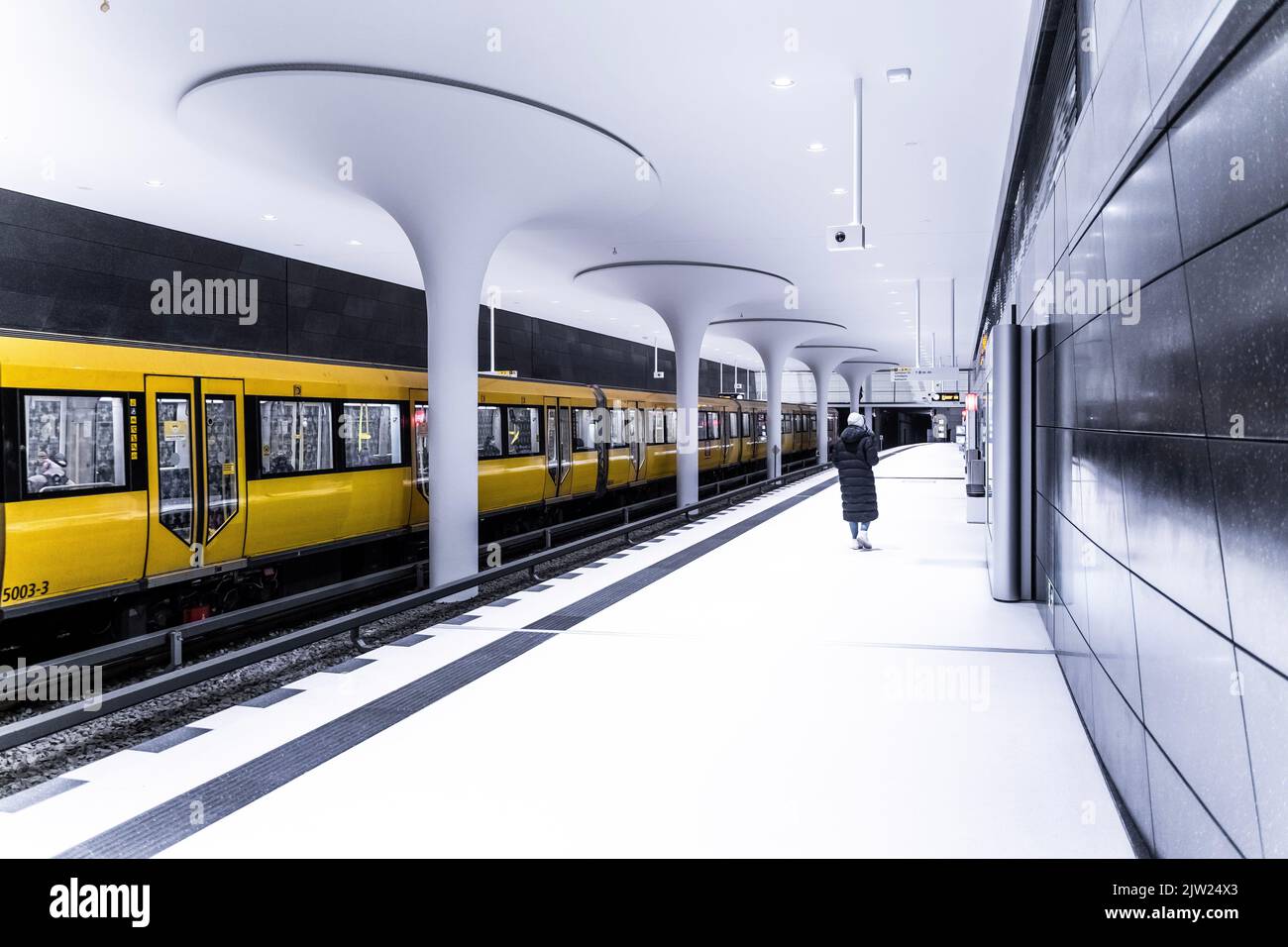 A yellow train waiting to depart at the Berlin subway station Stock ...