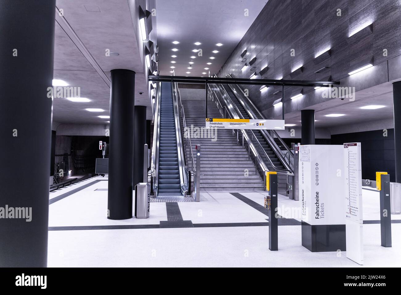 A view of the escalator and black columns of Berlin subway station ...