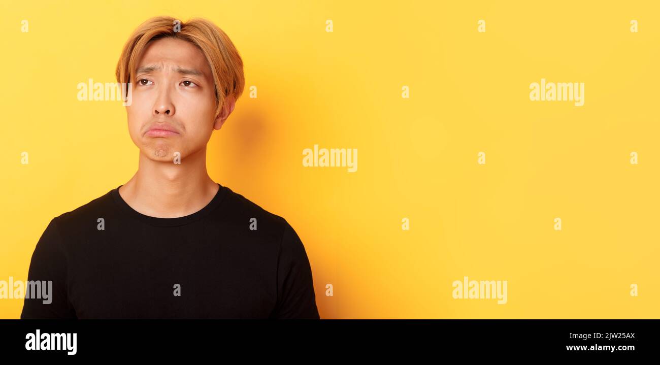 Close-up of sad and disappointed handsome asian guy sulking upset ...