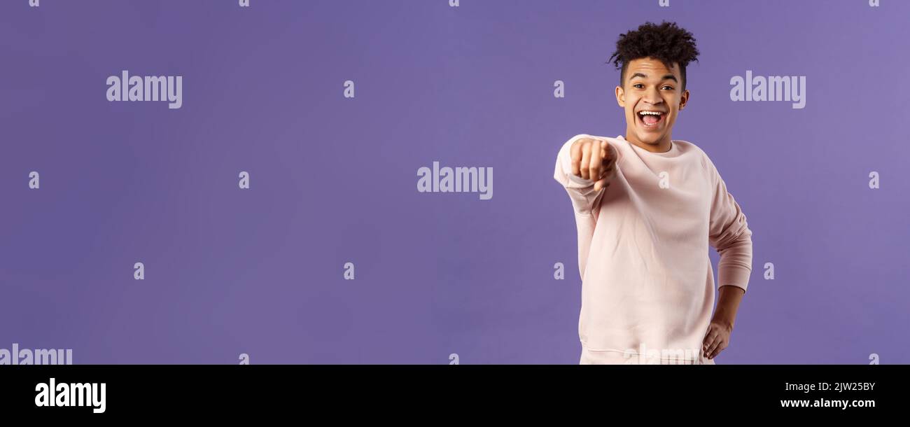 Portrait of outgoing happy hispanic male student making his choice ...