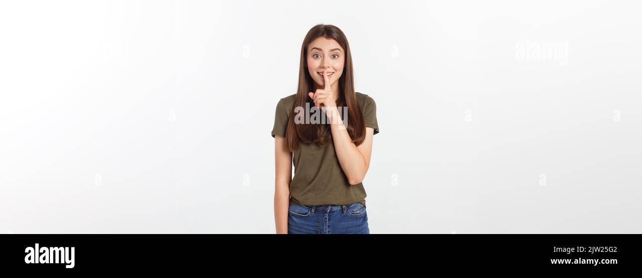 Beautiful woman showing finger over lips isolated on a white background ...