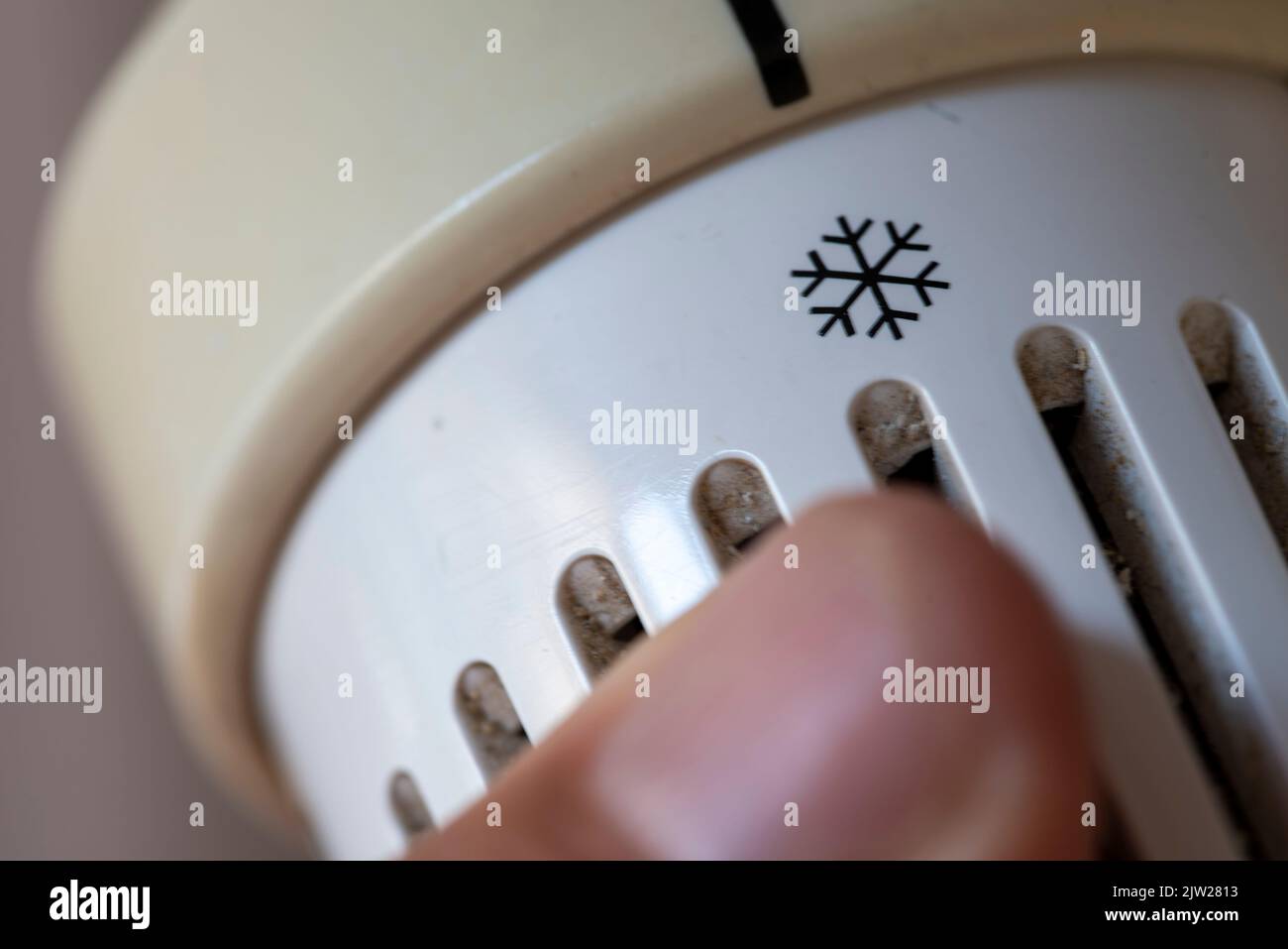 Hand regulates thermostat, heating Stock Photo - Alamy