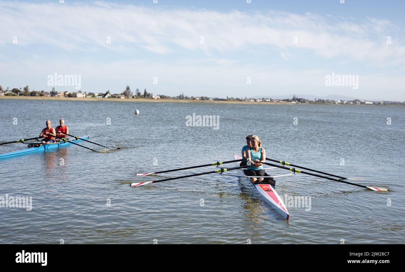 Two senior caucasian rowing teams rowing the boat on the lake Stock ...