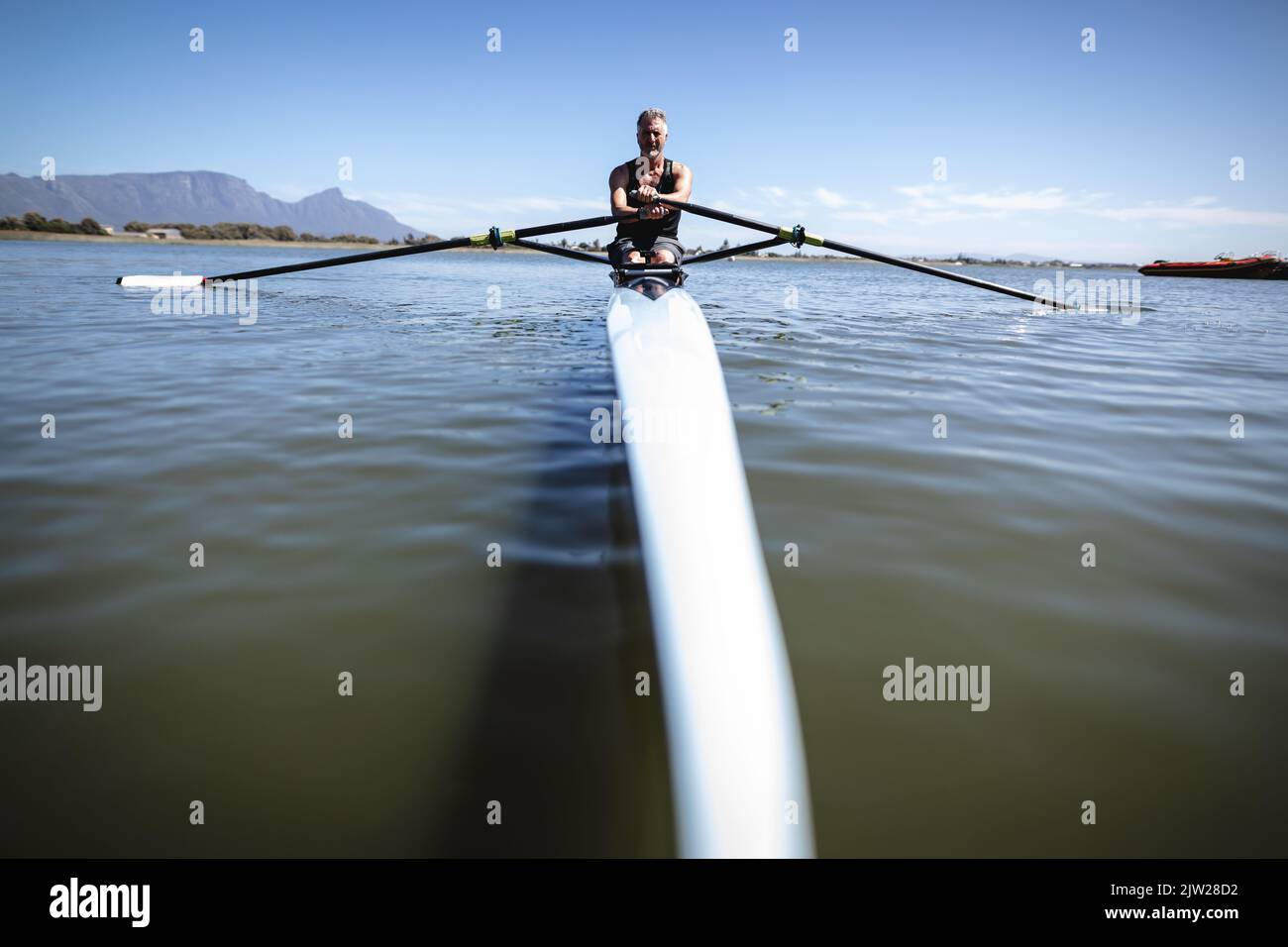 Senior caucasian male rower rowing the boat on the lake Stock Photo - Alamy