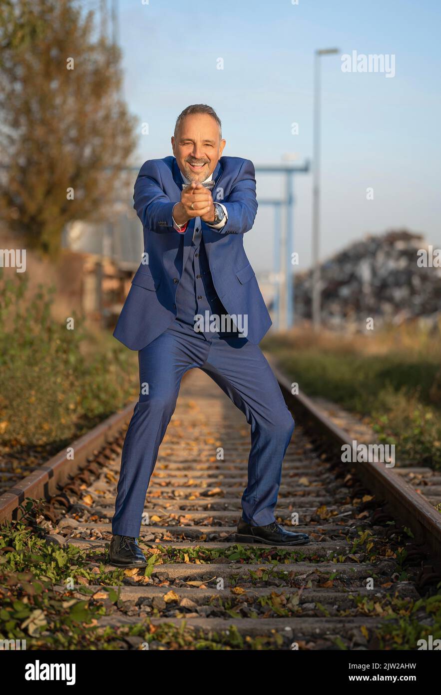 Crazy mafia boss laughs and stretches hands forward as a weapon ...