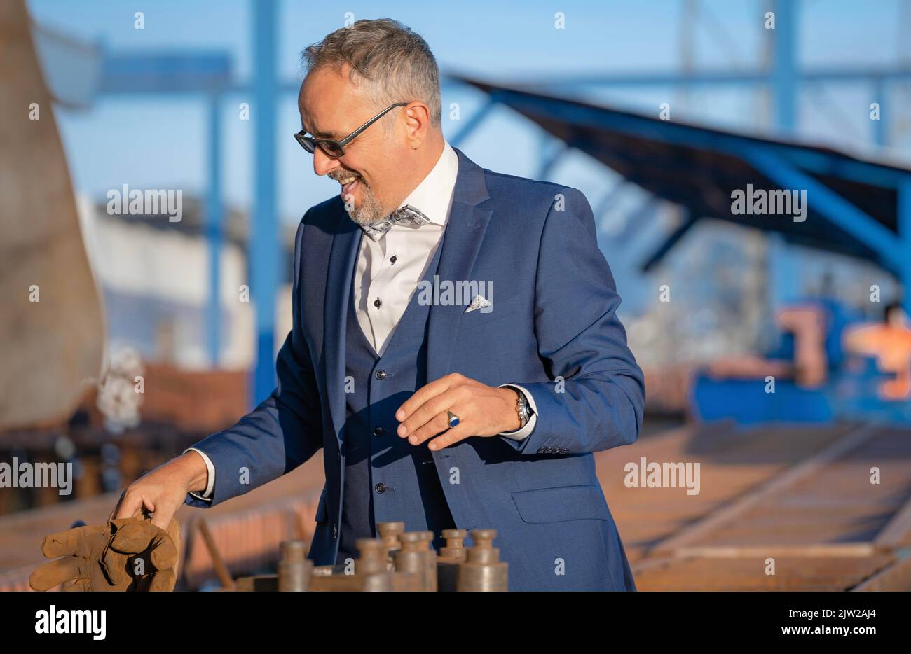 Laughing mafia boss in blue suit at the harbour, Rheinhafen, Karlsruhe ...