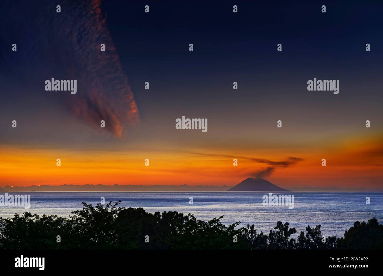 Strompoli volcano with plumes of smoke at sunset, Capo Vaticano ...