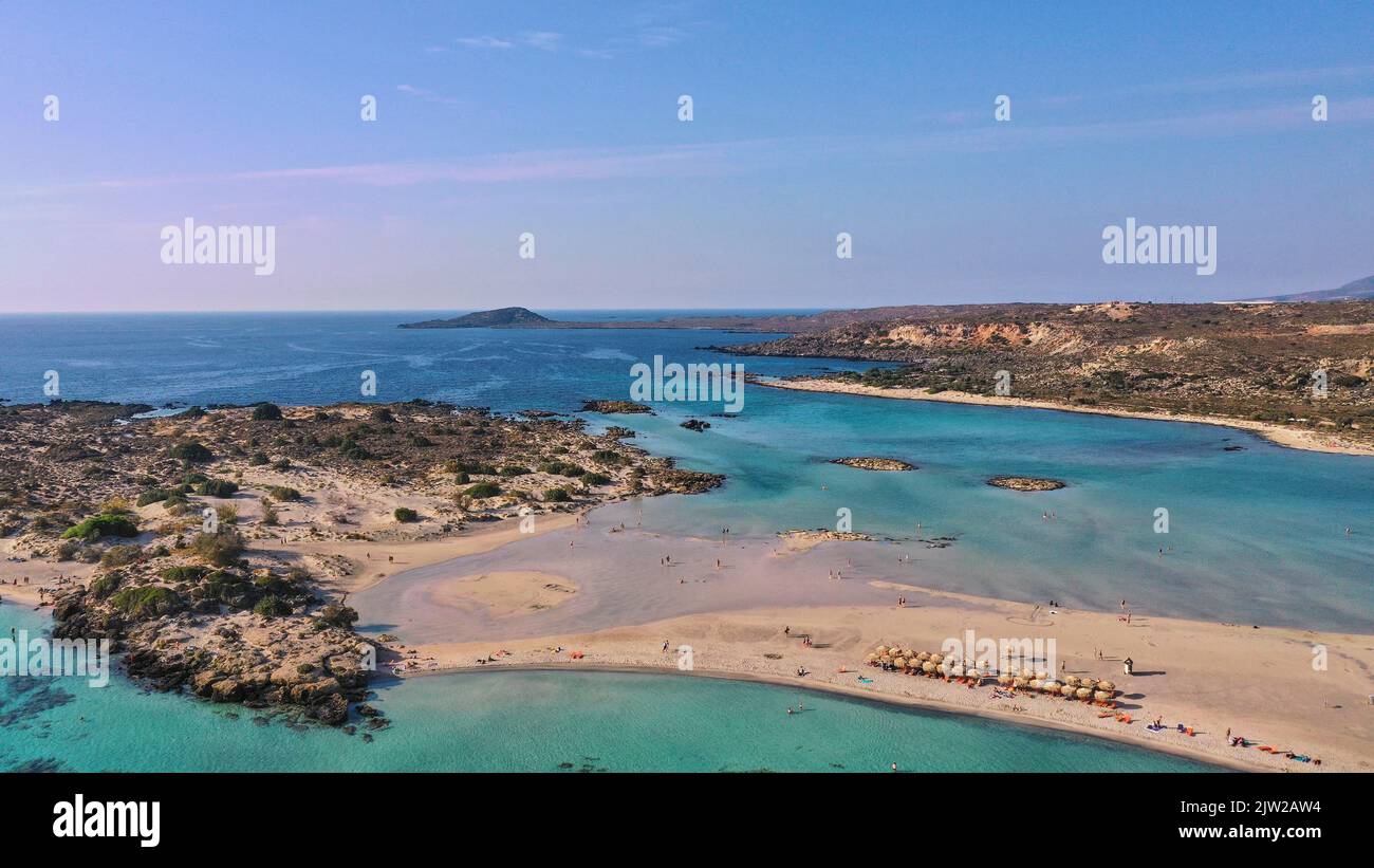 Drone shot, sandbank, rocky islet, parasols, tourists, blue sea ...