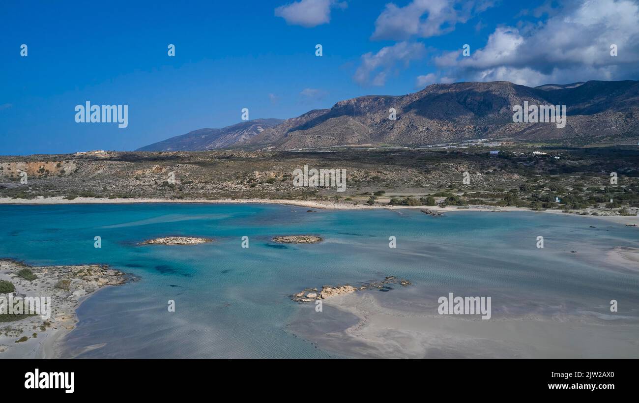 Shallow water of the lagoon, deserted, blue sky with white clouds, two ...