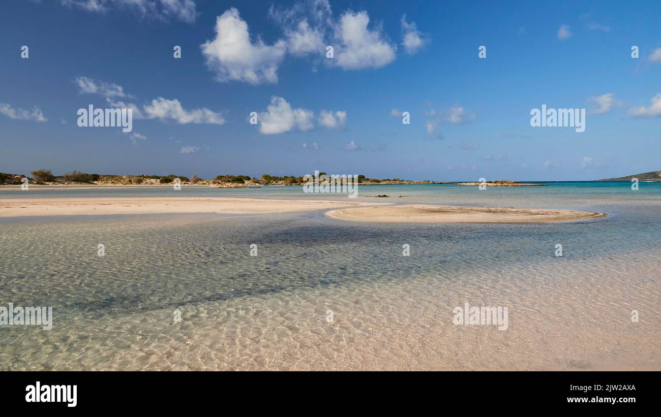 Shallow water of the lagoon, deserted, blue sky with white clouds ...