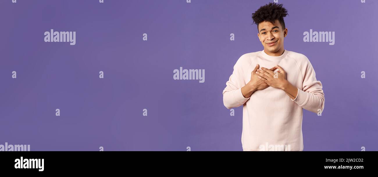 Portrait of touched silly young man left speechless and flattered ...