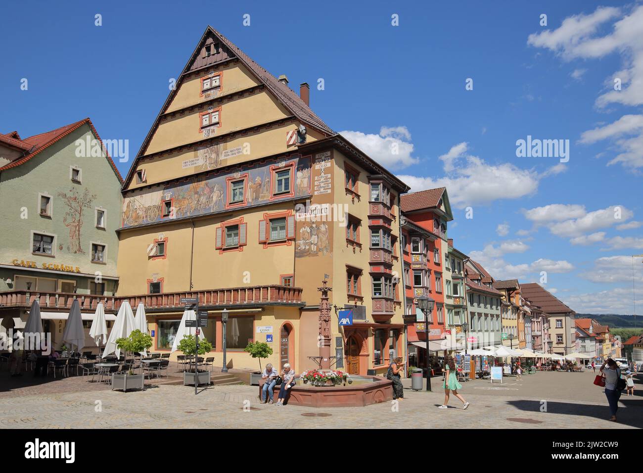 Yellow house with mural and fountain in the main street in Rottweil ...