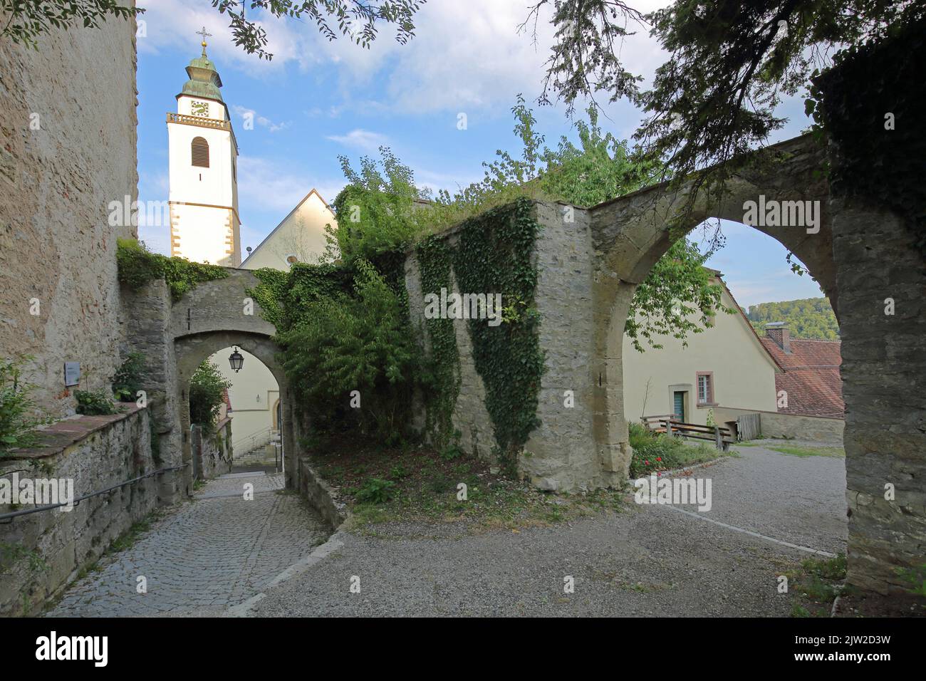Castle garden with archway as historic town fortification with church ...