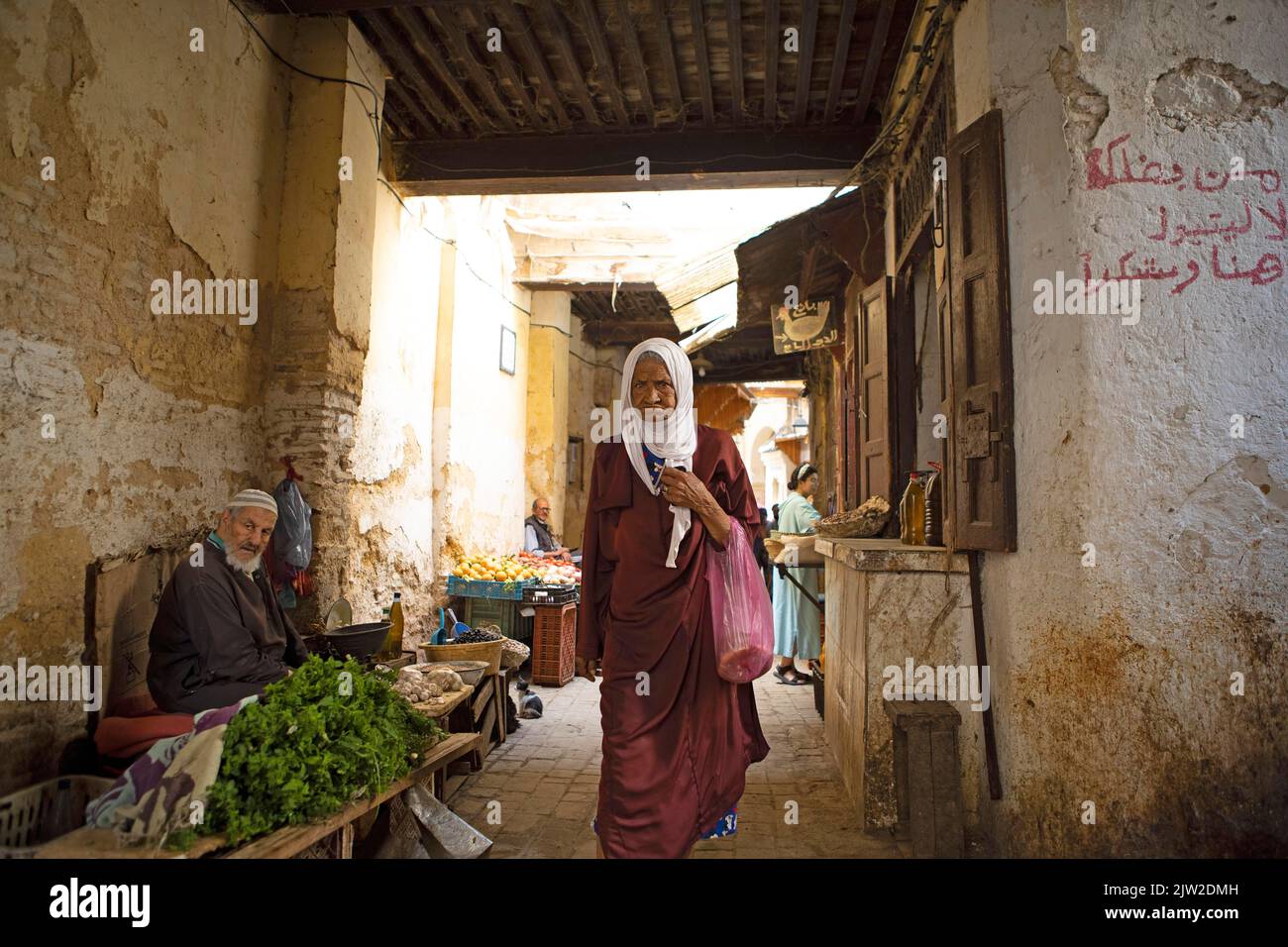 Old Moroccan woman in an old town alley, Fez, Morocco Stock Photo - Alamy