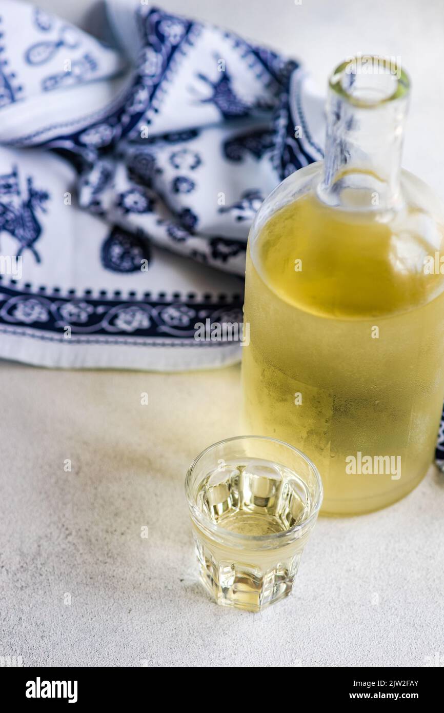 Georgian grape chacha drink in the bottle and glasses on grey concrete ...