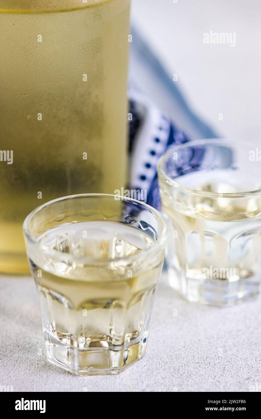 Georgian grape chacha drink in the bottle and glasses on grey concrete ...