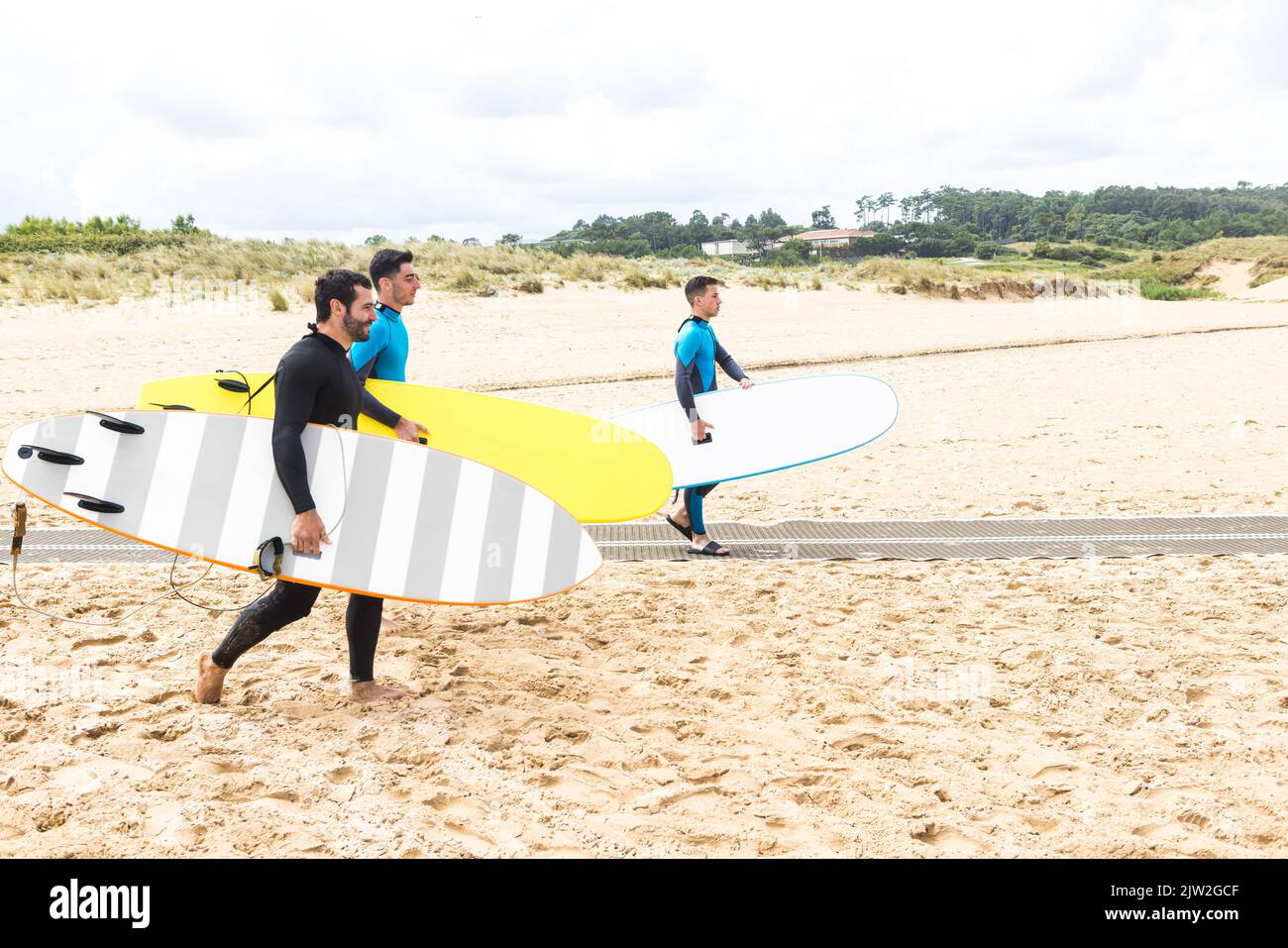 Side view of positive fit young ethnic male friends with dark hair in ...