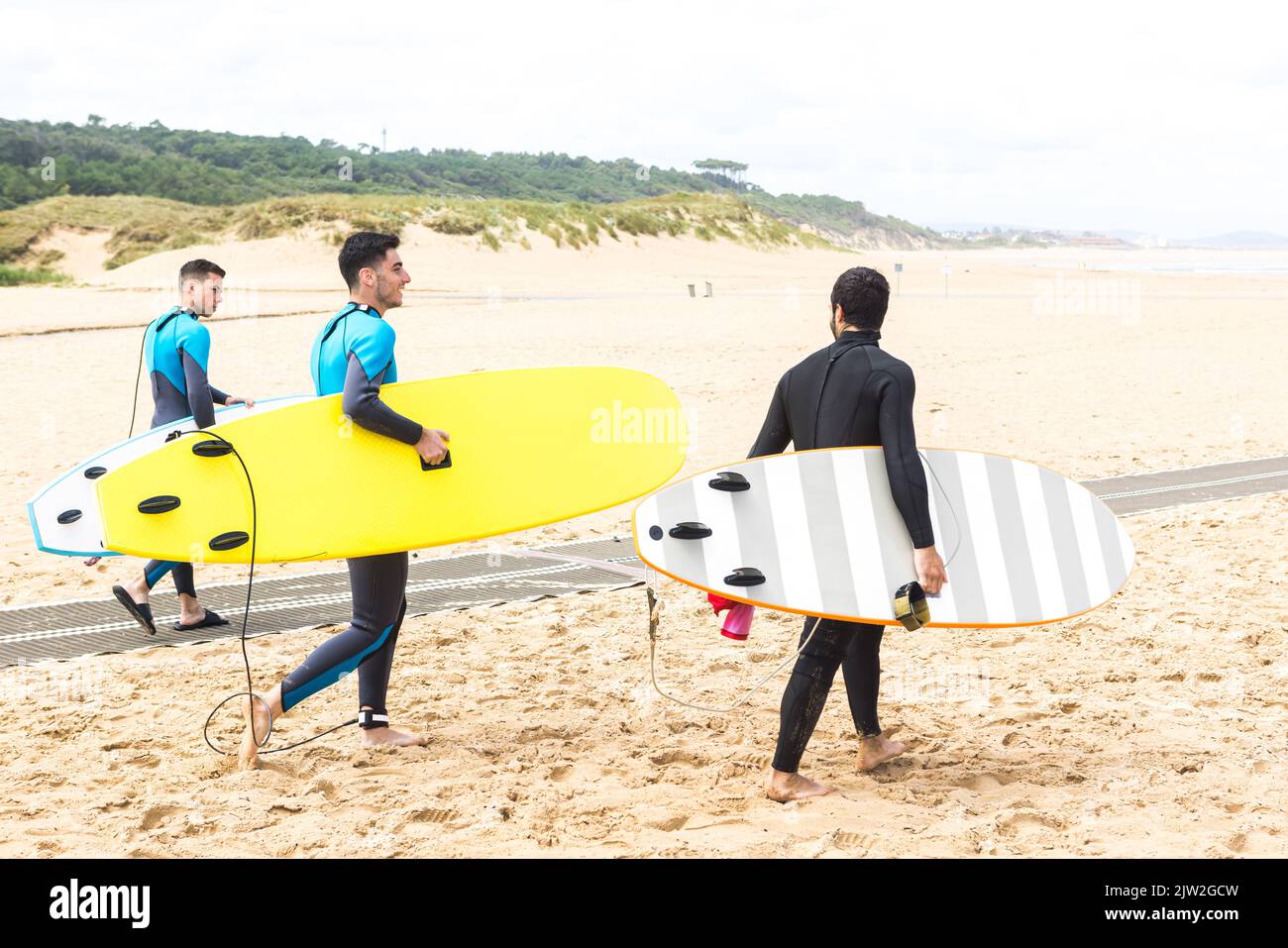 Side view of positive fit young ethnic male friends with dark hair in ...