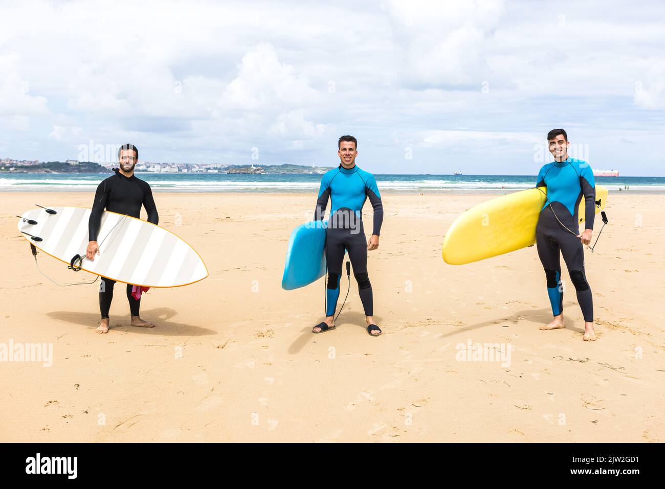 Positive fit young ethnic male friends with dark hair in wetsuits ...