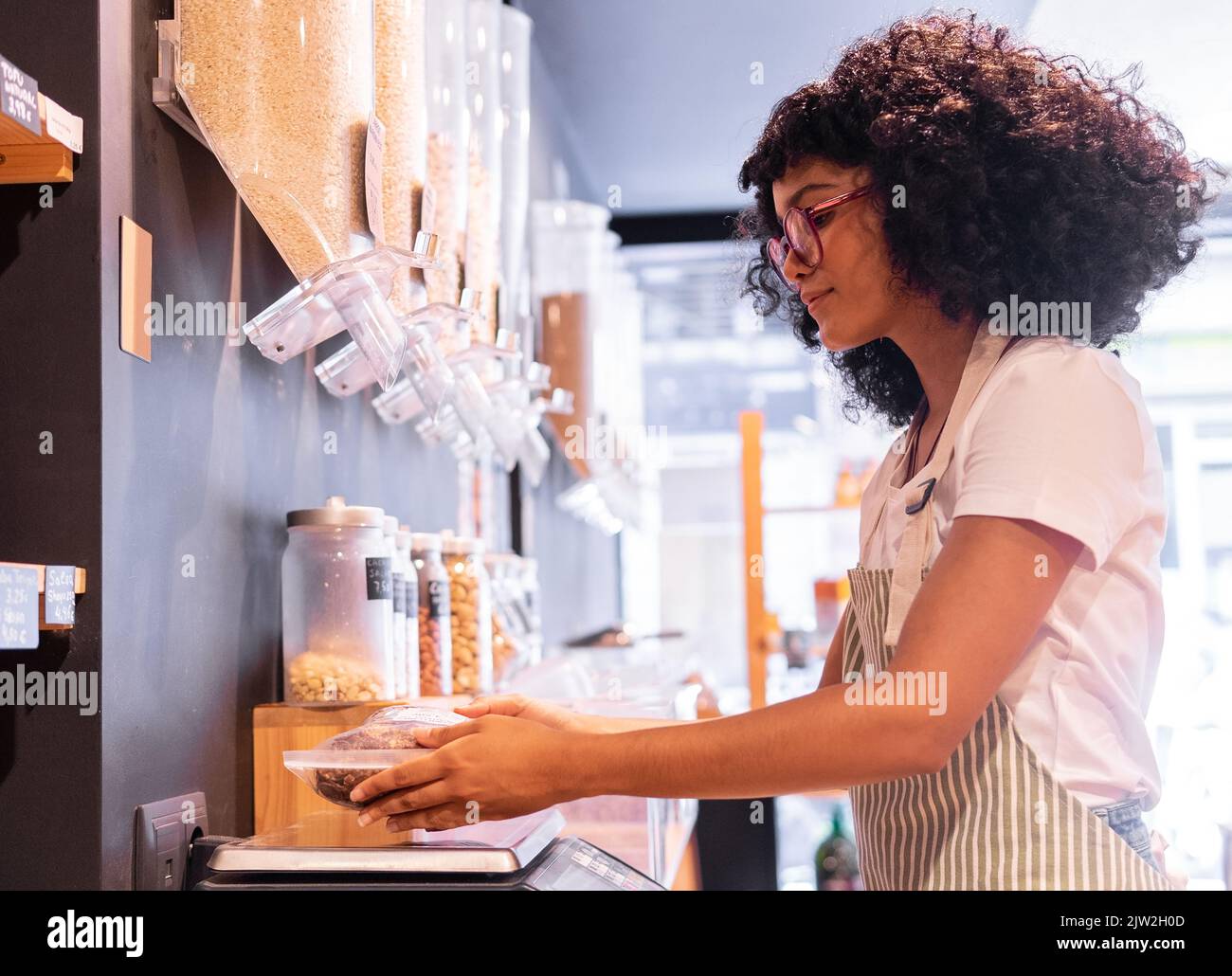 Side view young African American woman pressing buttons on digital ...