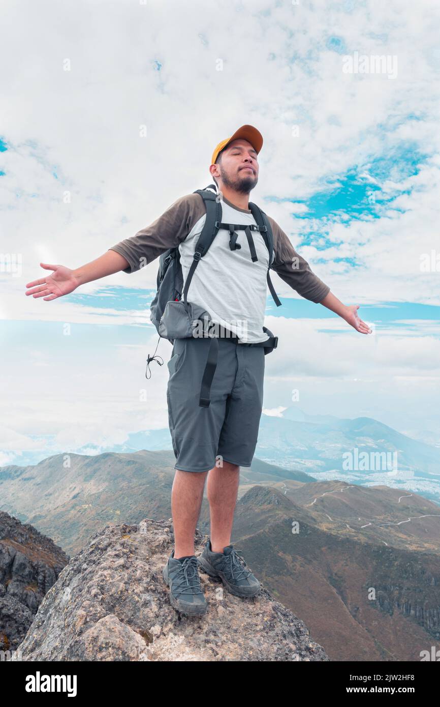 Full body of carefree male hiker with backpack standing with ...