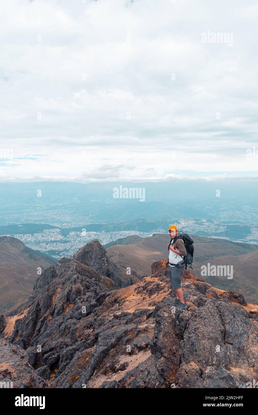 Side view of male hiker with backpack standing looking at camera on ...
