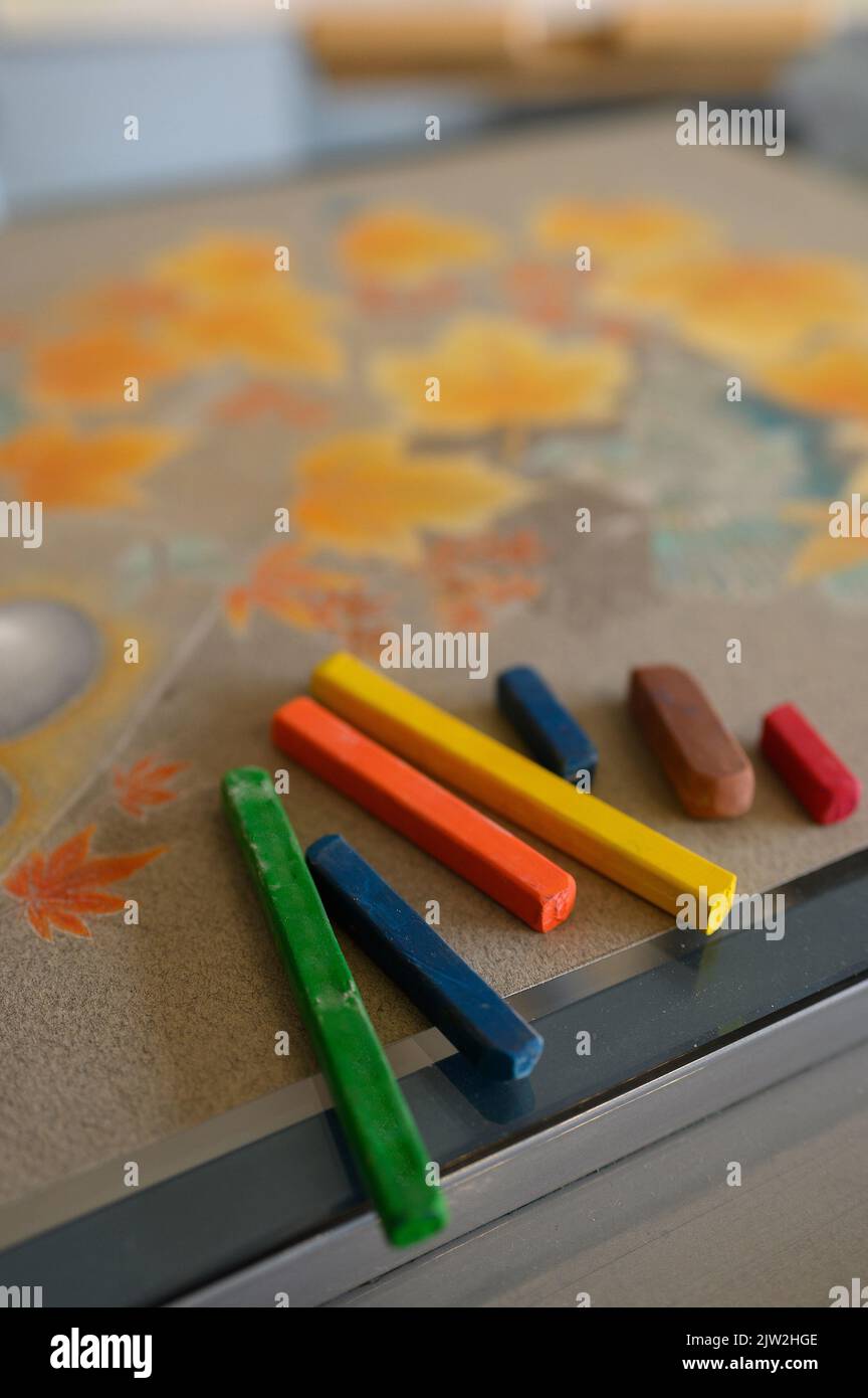 Top view of set of colorful pastel sticks placed on brown paper sheet ...