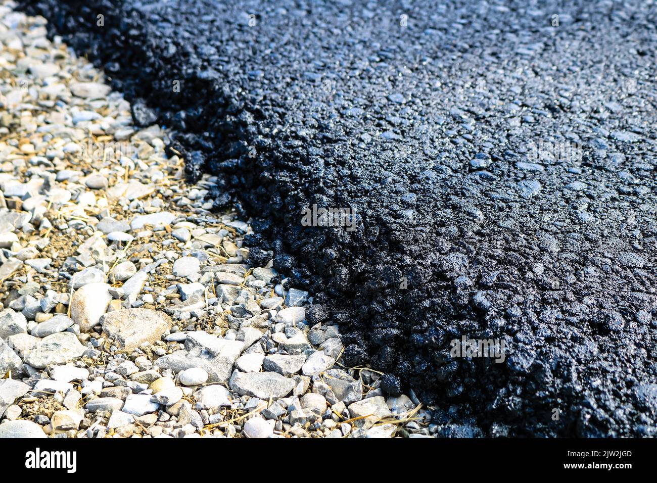 New layer of asphalt road under construction Stock Photo - Alamy