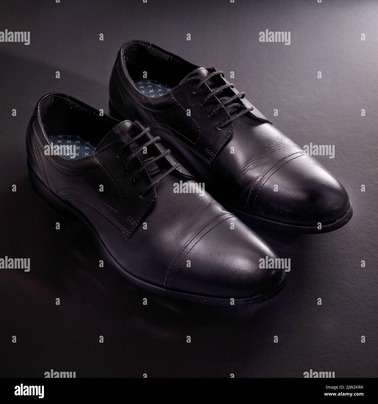 A pair of black shiny leather man shoes on the floor Stock Photo - Alamy