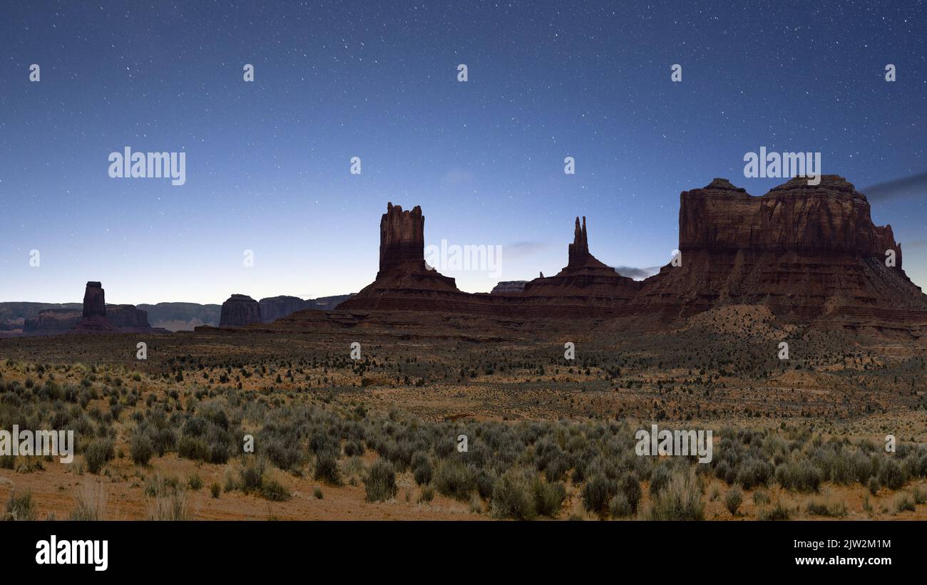 Breathtaking view of arid desert with bushes and uneven mountains ...