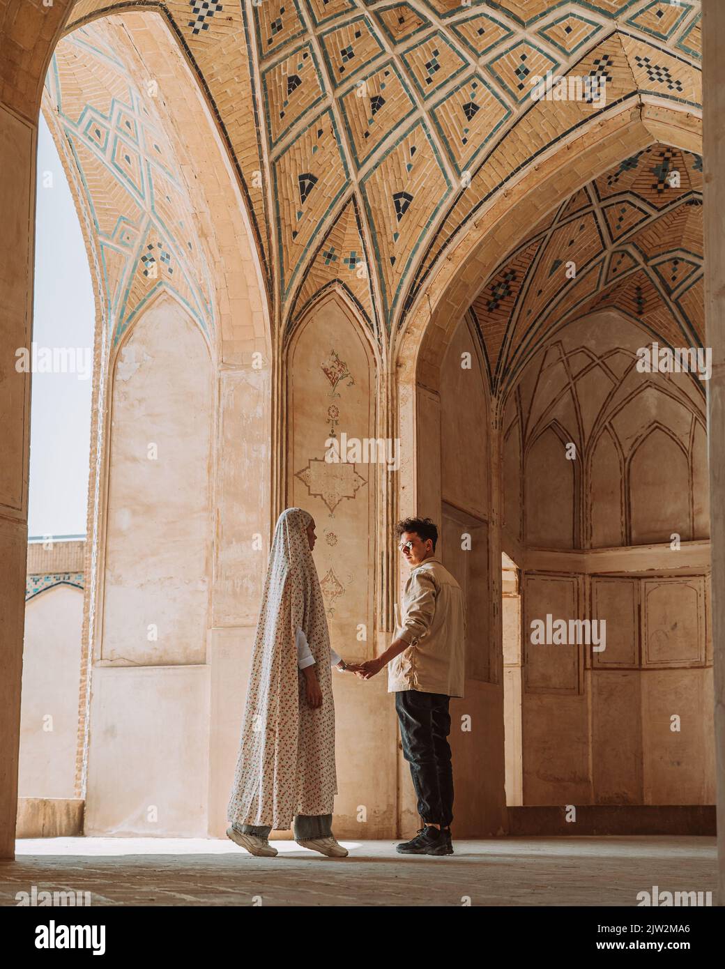 Full body side view of woman in authentic clothes holding hands with ...