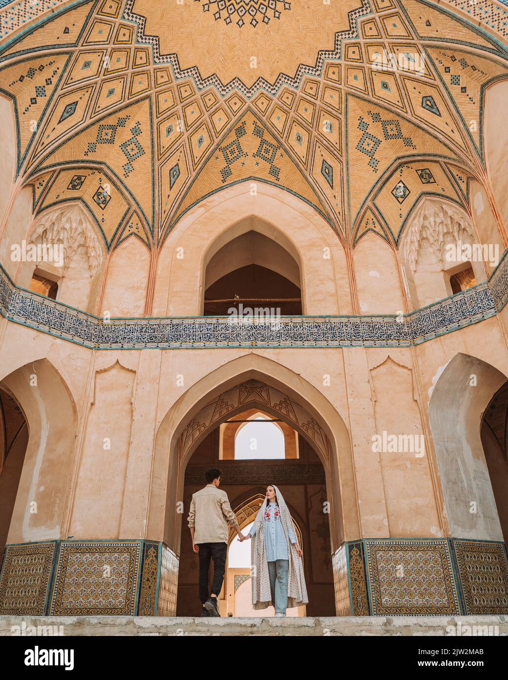 Ground level full body of woman in traditional clothes holding hands ...