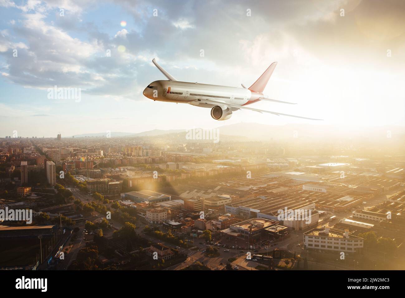 Side view of a commercial airplane flying over urban areas at sunset ...