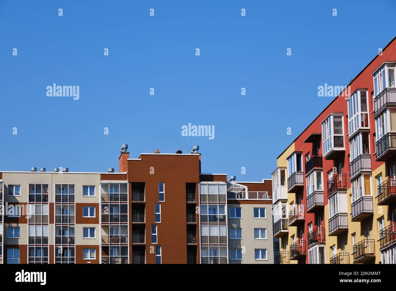 Multi-storey townhouses with balconies at the front against the clear ...