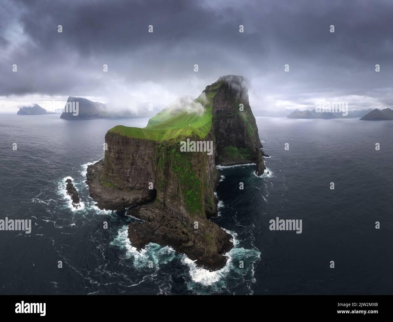 Breathtaking drone view of island with rough rocky cliffs covered with ...
