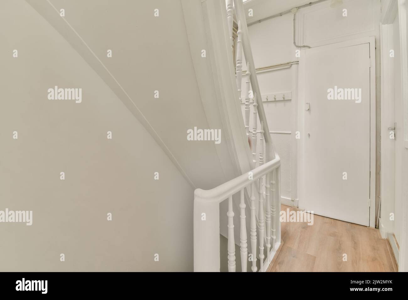 Interior of a house with stairs to an down and up floor in a bright ...