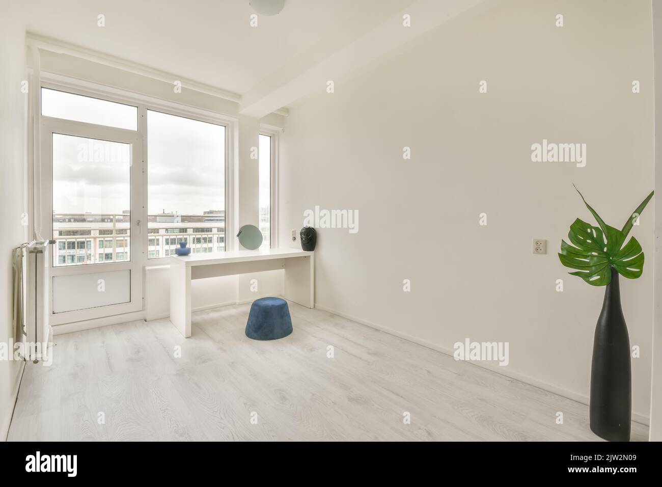 Bright room with a table under a bright window Stock Photo - Alamy