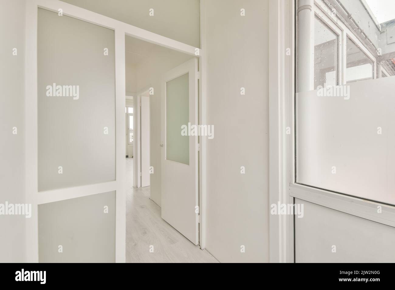 Interior passage way with glass door in modern house and white walls Stock Photo - Alamy
