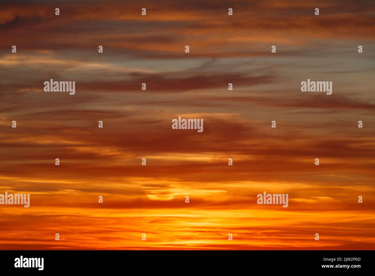 The setting sun lighting up the horizon Stock Photo - Alamy
