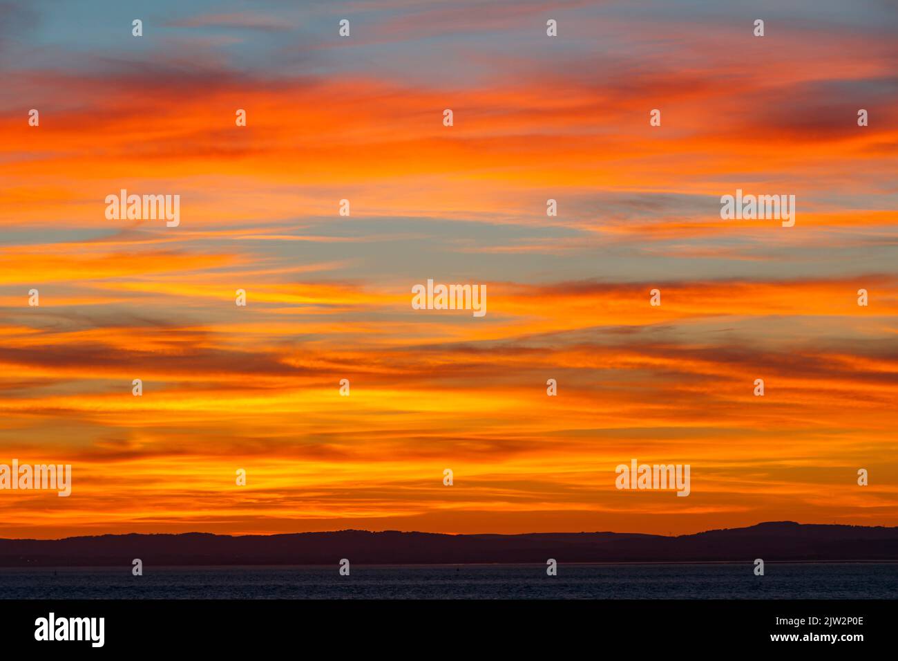 The setting sun lighting up the horizon Stock Photo - Alamy